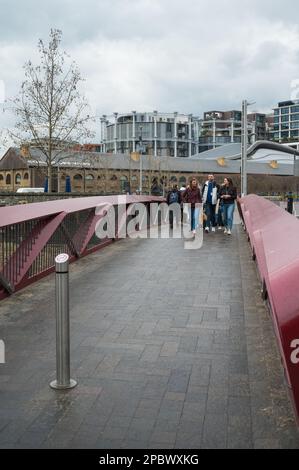 People crossing Esperance Bridge over the Regents Canal, Granary Square ...