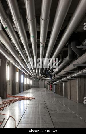 Ceiling mounted industrial pipelines inside underground building, Long ...