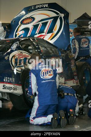 Kurt Busch's crew work on his car in the garage before a practice ...