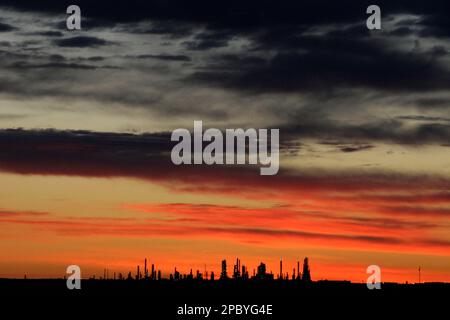 The sun rises behind the Valero McKee Refinery, where a small fire ...