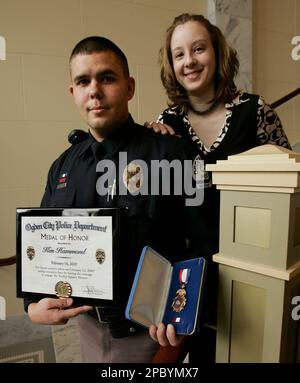 Ogden City Master Officer Ken Hammond reacts to being given a medal of ...