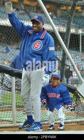 Chicago Cubs manager Dusty Baker follows the flight of a fly ball while ...