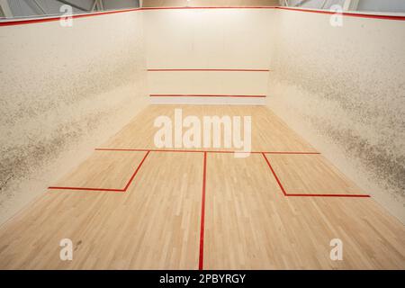 Empty squash court ultra-wide angle view. Racket and ball on the ground ...