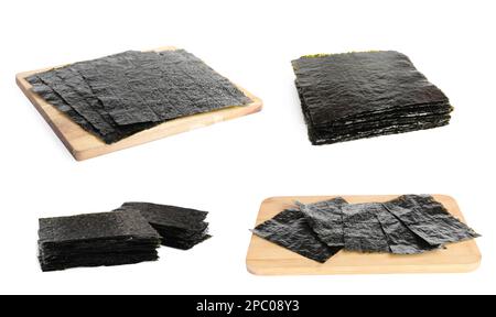 Wooden board with cut nori sheets, rice and soy sauce on white ...