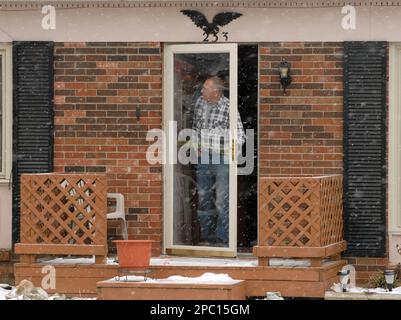 Fire officials examine the site of a house fire Tuesday, Feb. 6, 2007 ...