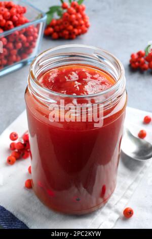 Jar of delicious rowan jam on wooden table Stock Photo - Alamy