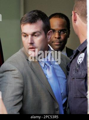 Sgt. Robert Gisevius Jr., left, hugs a fellow officer as he and six ...