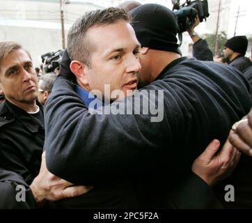 Sgt. Robert Gisevius Jr., center, turns himself in at police ...