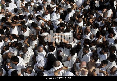 Muslim pilgrims cast stones at pillars in the symbolic stoning of the ...