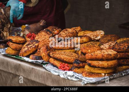 Smoking bio natural seasoned cheese with spices in a smoker in a street ...