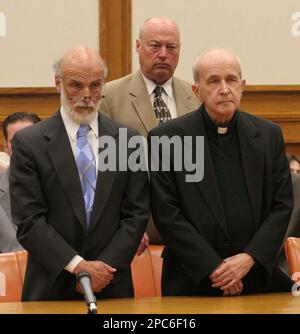 The Rev. Gerald Robinson, right, listens with his defense attorney Alan ...