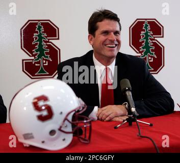 New Stanford head football coach Jim Harbaugh smiles during a news ...