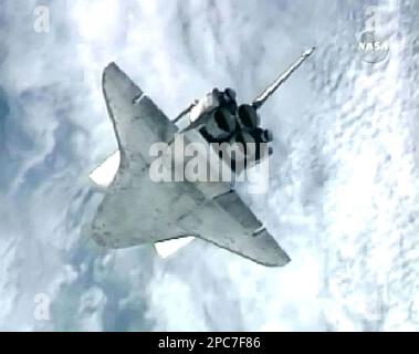 Space shuttle Discovery executes a 360 degree rotational pitch maneuver ...