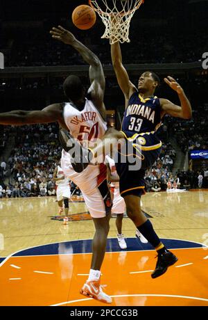 Charlotte Bobcats' Emeka Okafor (50) is guarded by Philadelphia 76ers ...