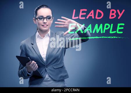 Businesswoman in the lead by example concept Stock Photo - Alamy