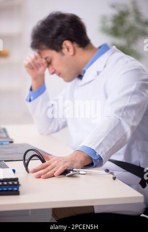 Young doctor being tired after night shift Stock Photo - Alamy