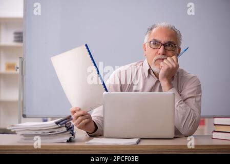 Old teacher in front of whiteboard in time management concept Stock ...