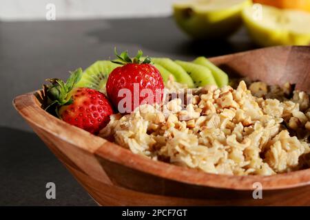Oatmeal with fruits on table close-up Stock Photo - Alamy