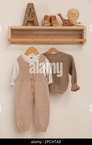 Baby booties with toys on brown background. Different color patterns ...
