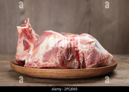 Plate with raw chopped meaty bones isolated on white Stock Photo - Alamy