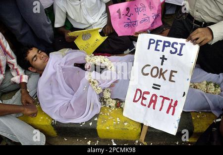 A college student acts as a dead man with a cola bottle placed on him ...
