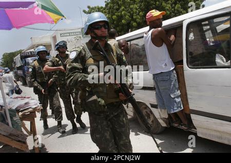 U.N. Brazilian peacekeepers patrol a street in the slum of Cite ...