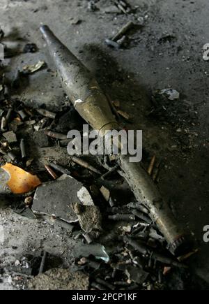 An unexploded rocket propelled grenade launcher and bullet casings are ...