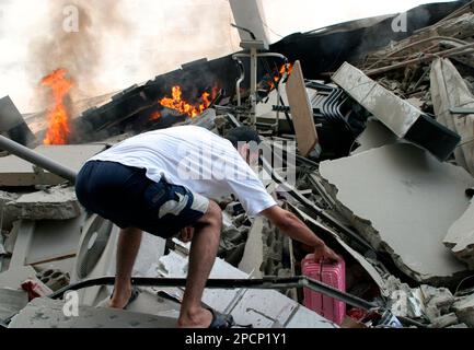 A Lebanese man tries to salvage toys from the rubble of a destroyed ...