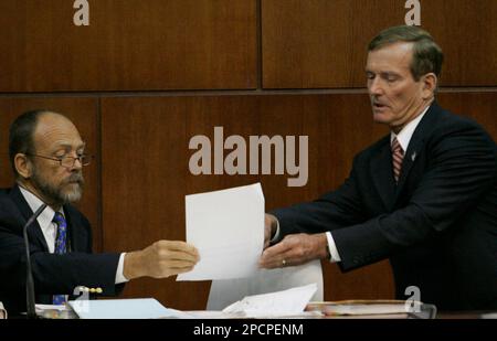 State Attorney John Tanner, right, shows photographs to be submitted as ...