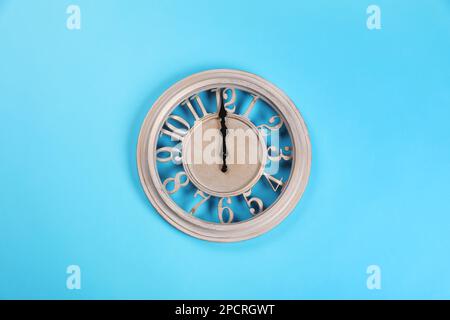 Stylish wall clock on turquoise background, top view Stock Photo - Alamy