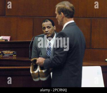 State Attorney John Tanner, right, shows photographs to be submitted as ...