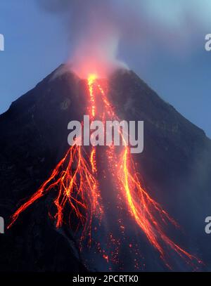 Lava flows down the slopes of Mayon volcano as seen from Legazpi, Albay ...