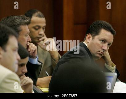 State attorney Leah Case, right, shows photographs of the body of Erin ...