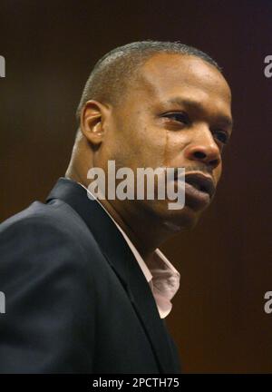 Former Fresno State basketball player Terry Pettis looks over paperwork ...