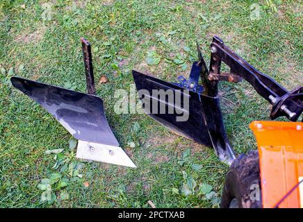 Plow and hiller complete with a walk-behind tractor for agricultural ...