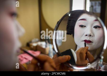 Toshiyu applying makeup in her Okiya (geisha house).Geisha from geisha ...