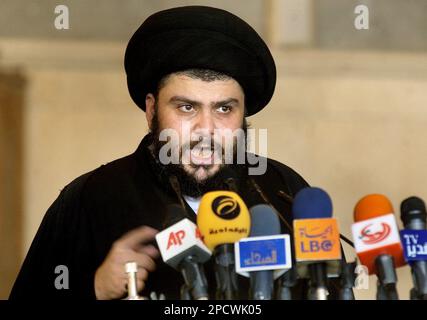 Radical Shiite cleric Muqtada al-Sadr's Mahdi Army militia men look at ...