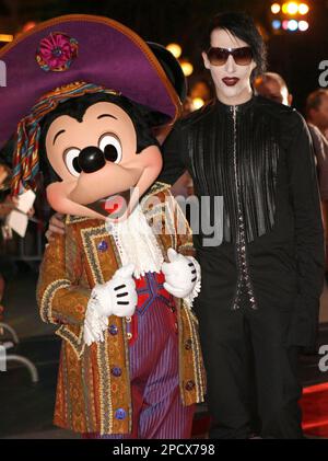 Musician Marylin Manson, right, and Mickey Mouse pose for photographers ...