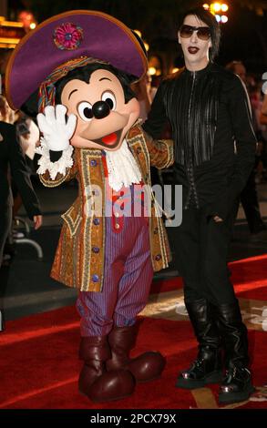 Musician Marylin Manson, right, and Mickey Mouse pose for photographers ...