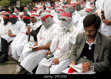 Iranian men wearing white shrouds indicating their willingness to give ...