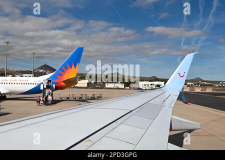 A wing of a Boeing 737 TUI chartered airplane taken in flight showing ...