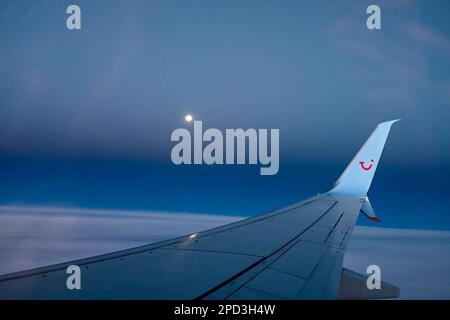 A wing of a Boeing 737 TUI chartered airplane taken in flight showing ...