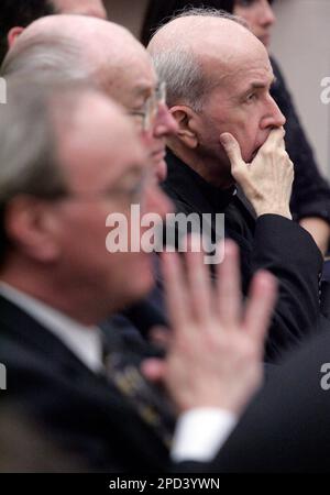 The Rev. Gerald Robinson, right, listens with his defense attorney Alan ...