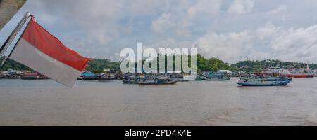View from the ferry to Waisai in Sorong with the flag of Indonesia ...