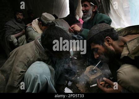 Pakistani addicts take drugs in their den situated in a junkie-slum in ...