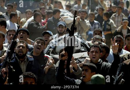 Palestinians carry fourteen bodies during the funeral procession for ...