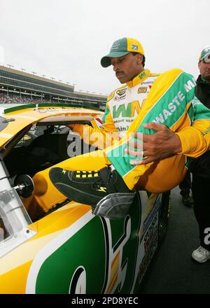 NASCAR driver Bill Lester climbs into is #23 Waste Management race car ...