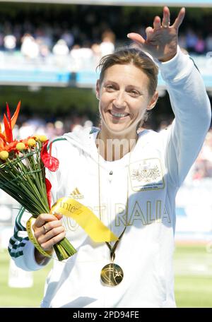 Australia's Kerryn McCann, the gold medal winner lays on the track at ...