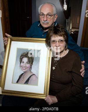 Rocco and Gee Gee DiPuccio hold a painting of their daughter Rosemarie ...