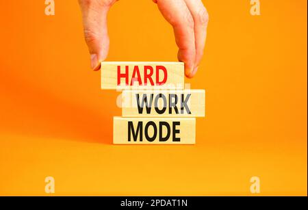 Hard work mode symbol. Concept words Hard work mode on wooden block on ...